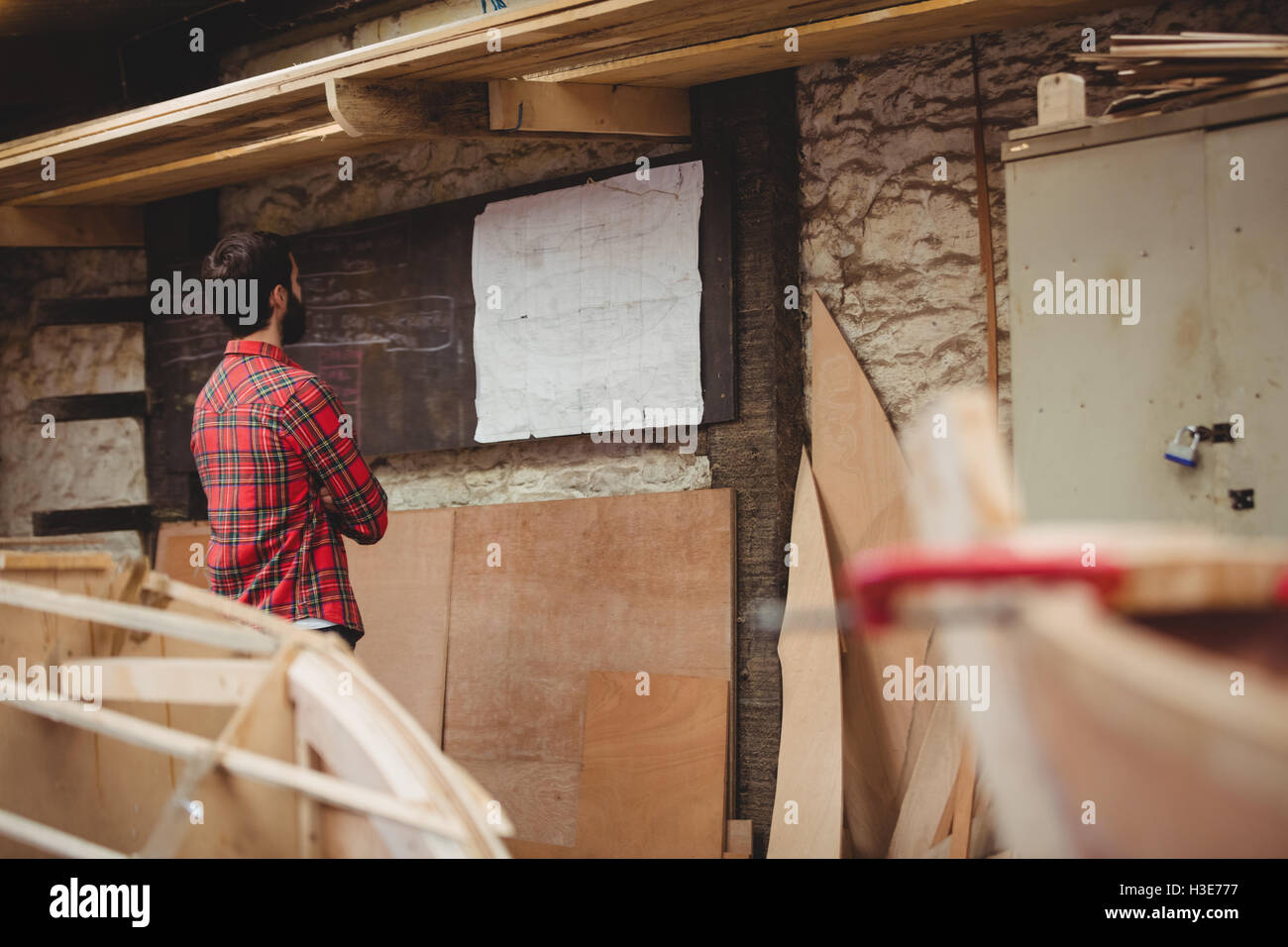 Man looking at blueprint Stock Photo - Alamy
