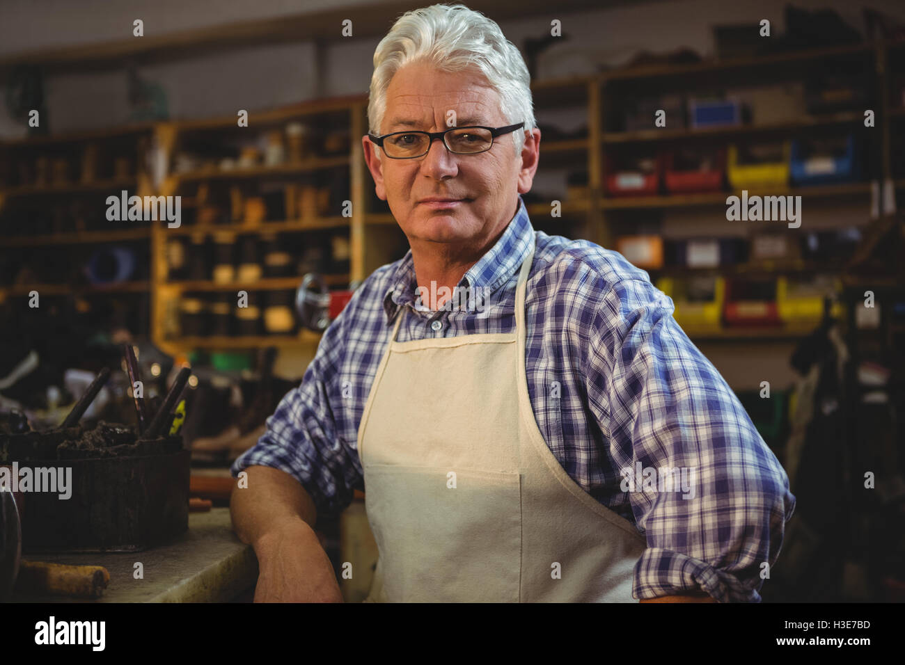 Portrait of shoemaker sitting in workshop Stock Photo - Alamy
