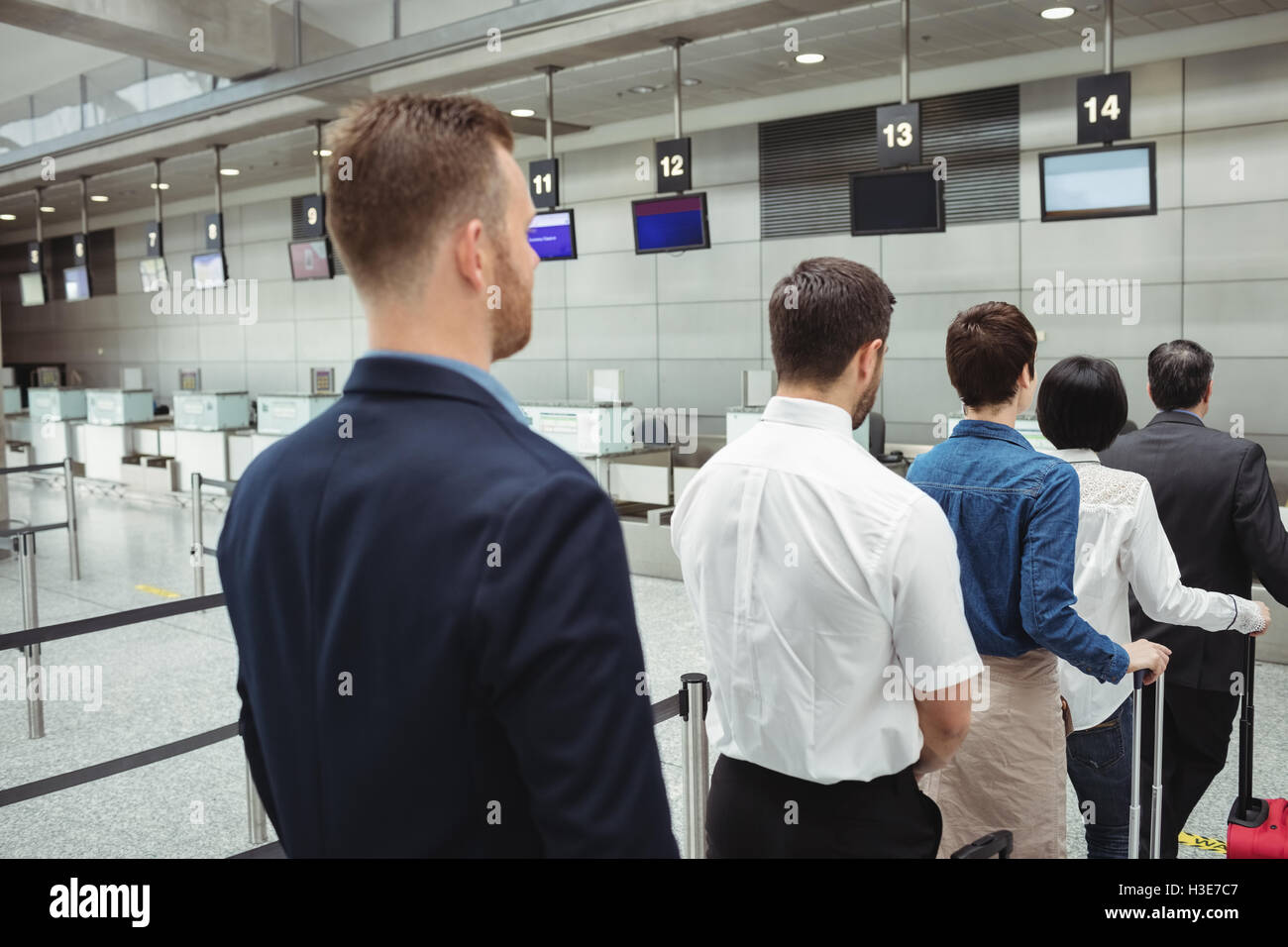 Passengers queue at a check in desk hi-res stock photography and images ...