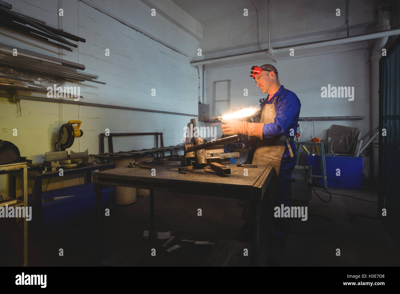 Male welder holding welding torch Stock Photo - Alamy