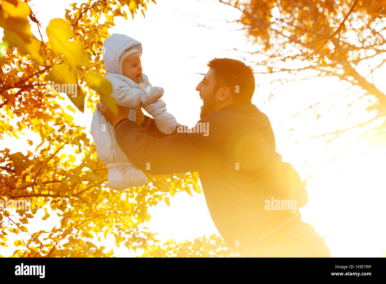 Daddy with the baby for a walk in the park, the father raises the child ...