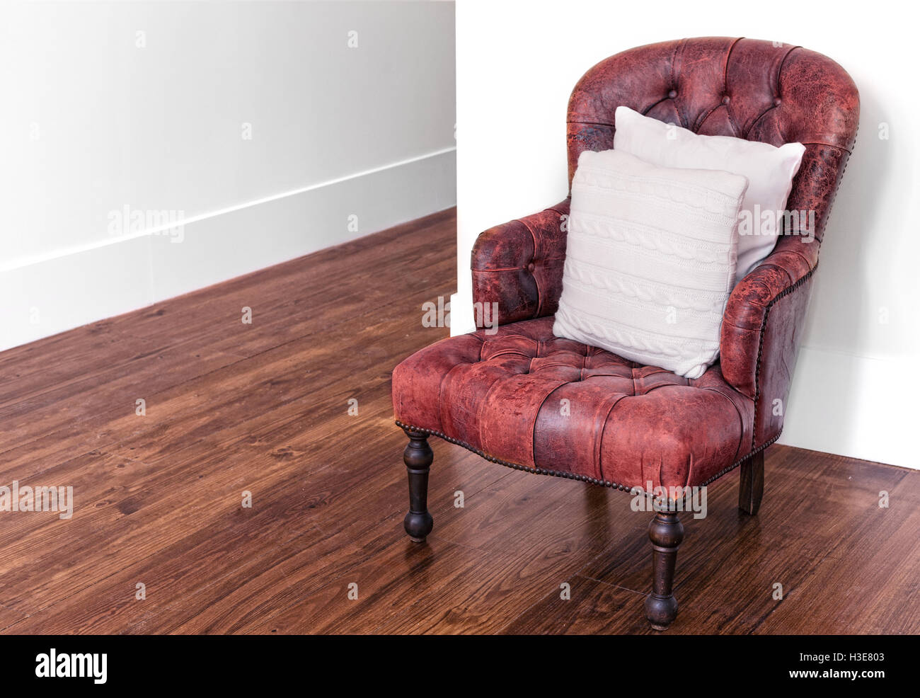 Classic luxury red leather armchair on wood floor Stock Photo - Alamy