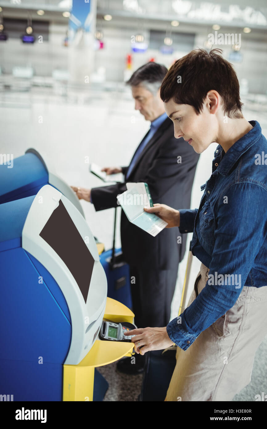 Business people using self service check-in machine Stock Photo - Alamy
