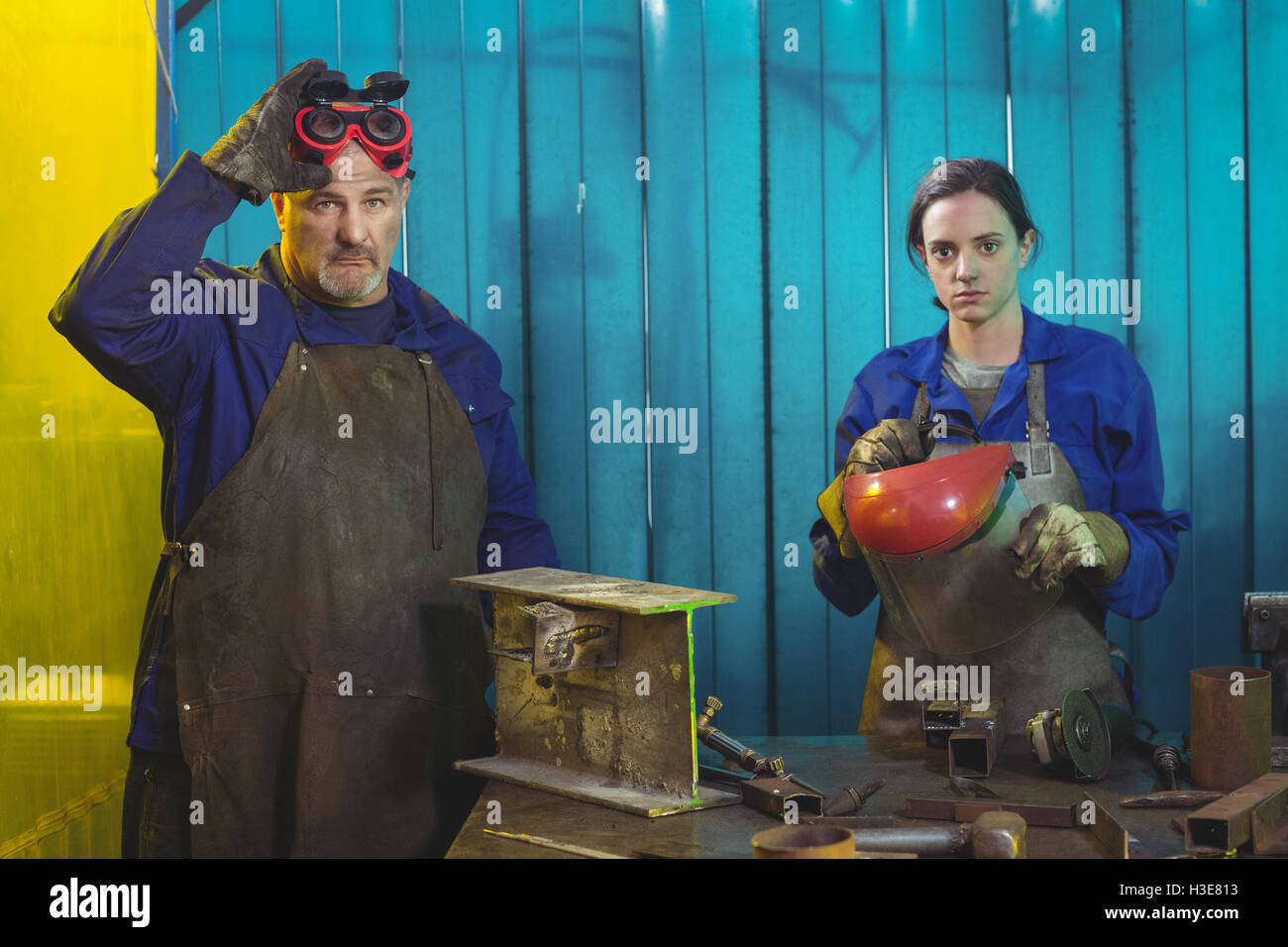 Portrait of male and female welder standing together Stock Photo - Alamy
