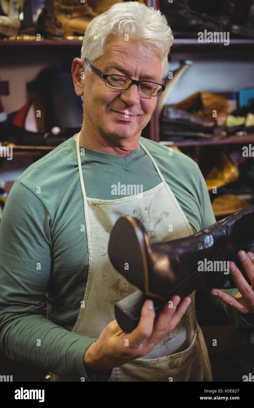 Shoemaker examining a shoe Stock Photo - Alamy