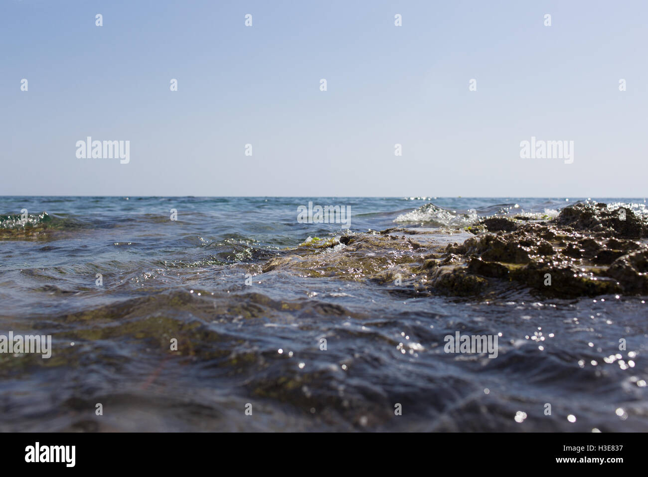 Sea wave splashing over the shore rocks with a high sea spray Stock ...