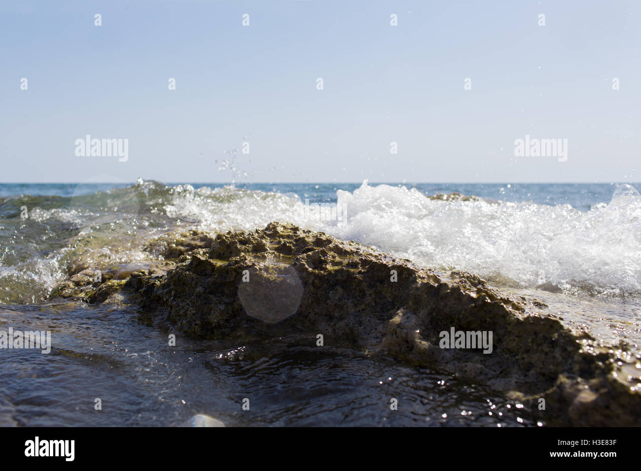 Sea wave splashing over the shore rocks with a high sea spray Stock ...