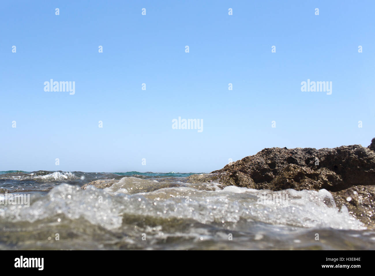 Sea wave splashing over the shore rocks with a high sea spray Stock ...