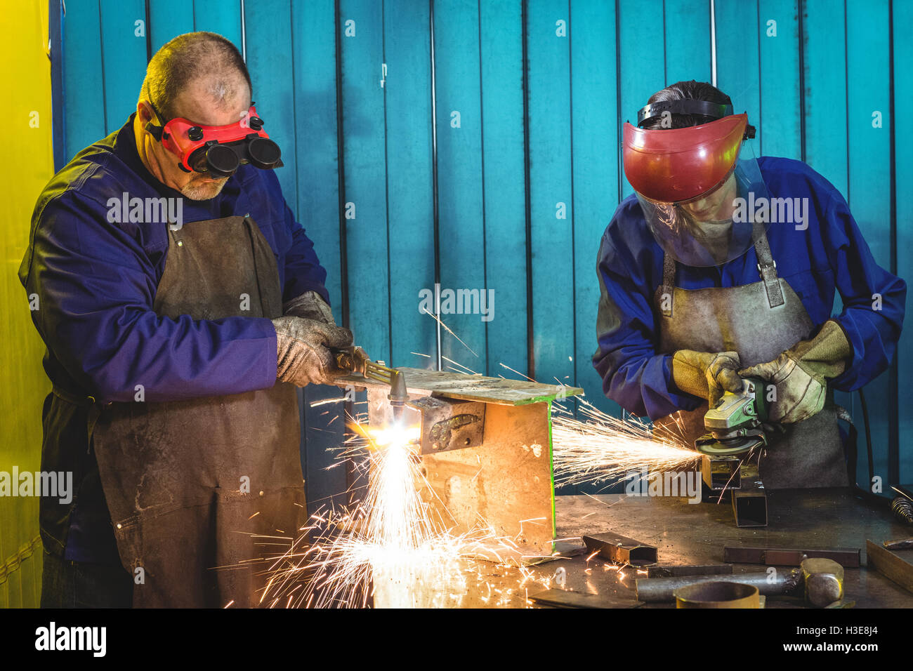Male and female welders working together Stock Photo - Alamy