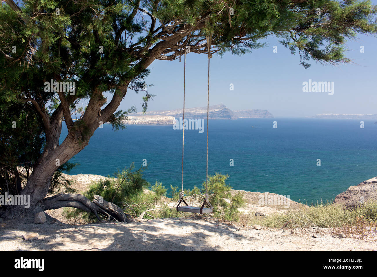 Swing over the precipice on the sea background Stock Photo - Alamy