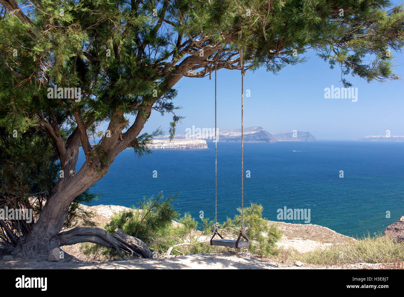 Swing over the precipice on the sea background Stock Photo - Alamy