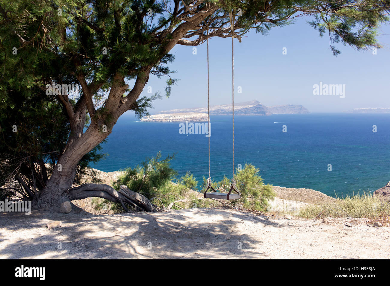 Swing over the precipice on the sea background Stock Photo - Alamy