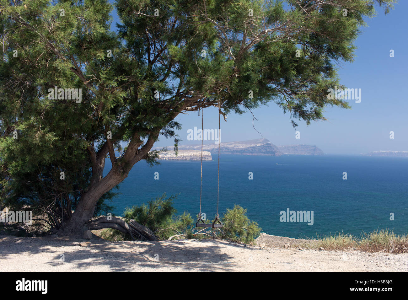 Swing over the precipice on the sea background Stock Photo - Alamy