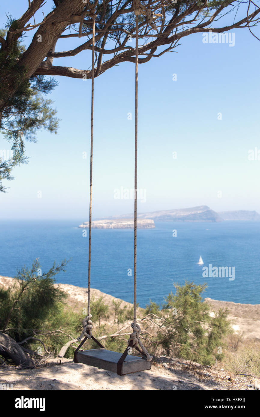 Swing over the precipice on the sea background Stock Photo - Alamy