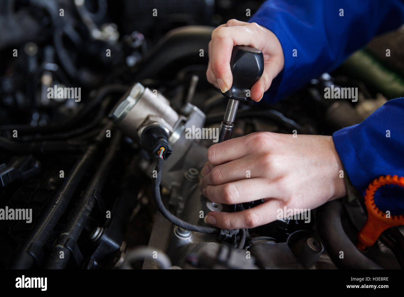 Mechanic servicing car engine Stock Photo - Alamy