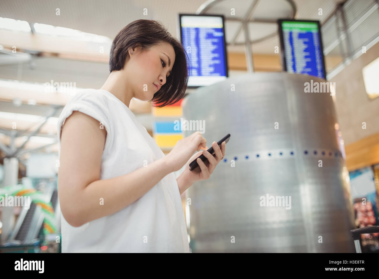 Young female passenger using mobile phone Stock Photo - Alamy