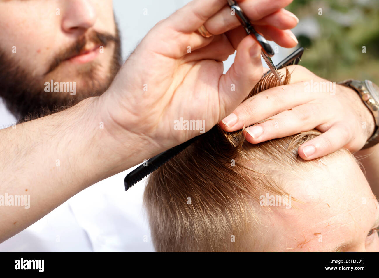 master hairdresser and stylist in the workflow closeup Stock Photo - Alamy