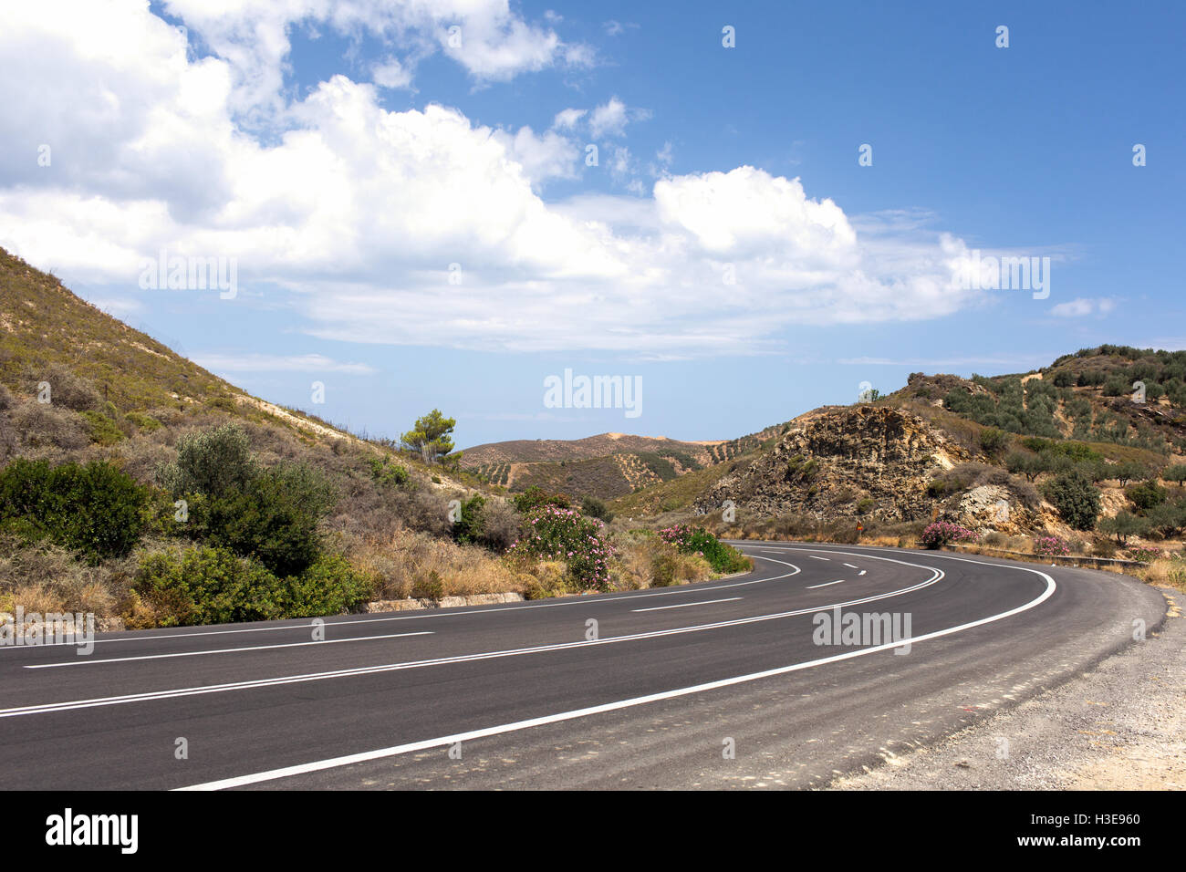 picturesque meandering asphalt road among hills and mountains Stock ...