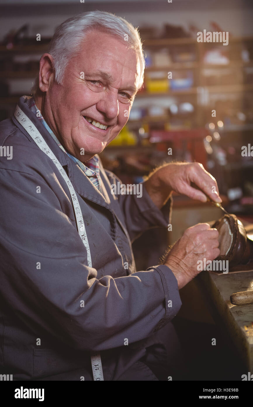 Portrait of shoemaker repairing a shoe Stock Photo - Alamy