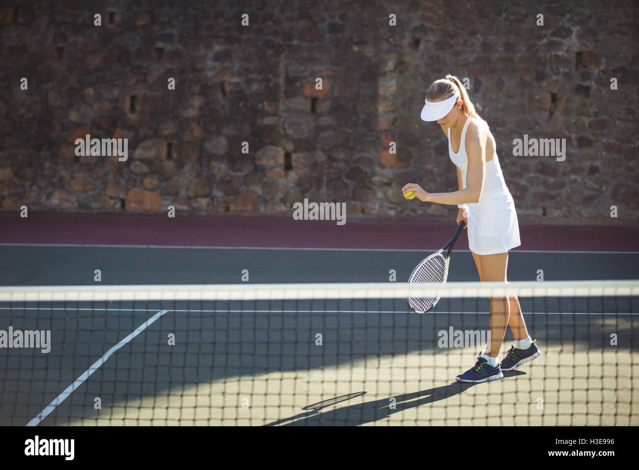 Woman with tennis racket ready to serve Stock Photo - Alamy