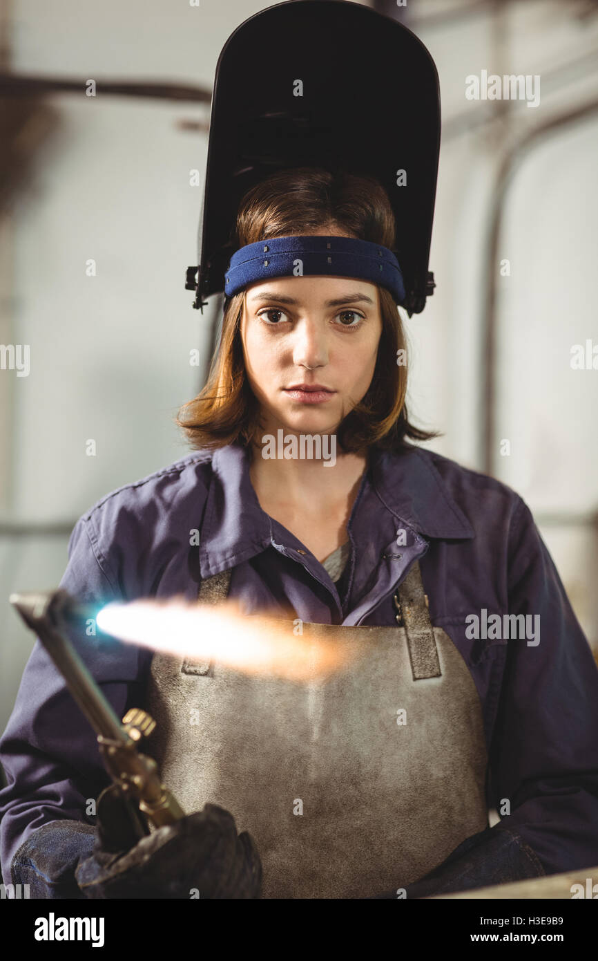 Female welder holding welding torch Stock Photo - Alamy