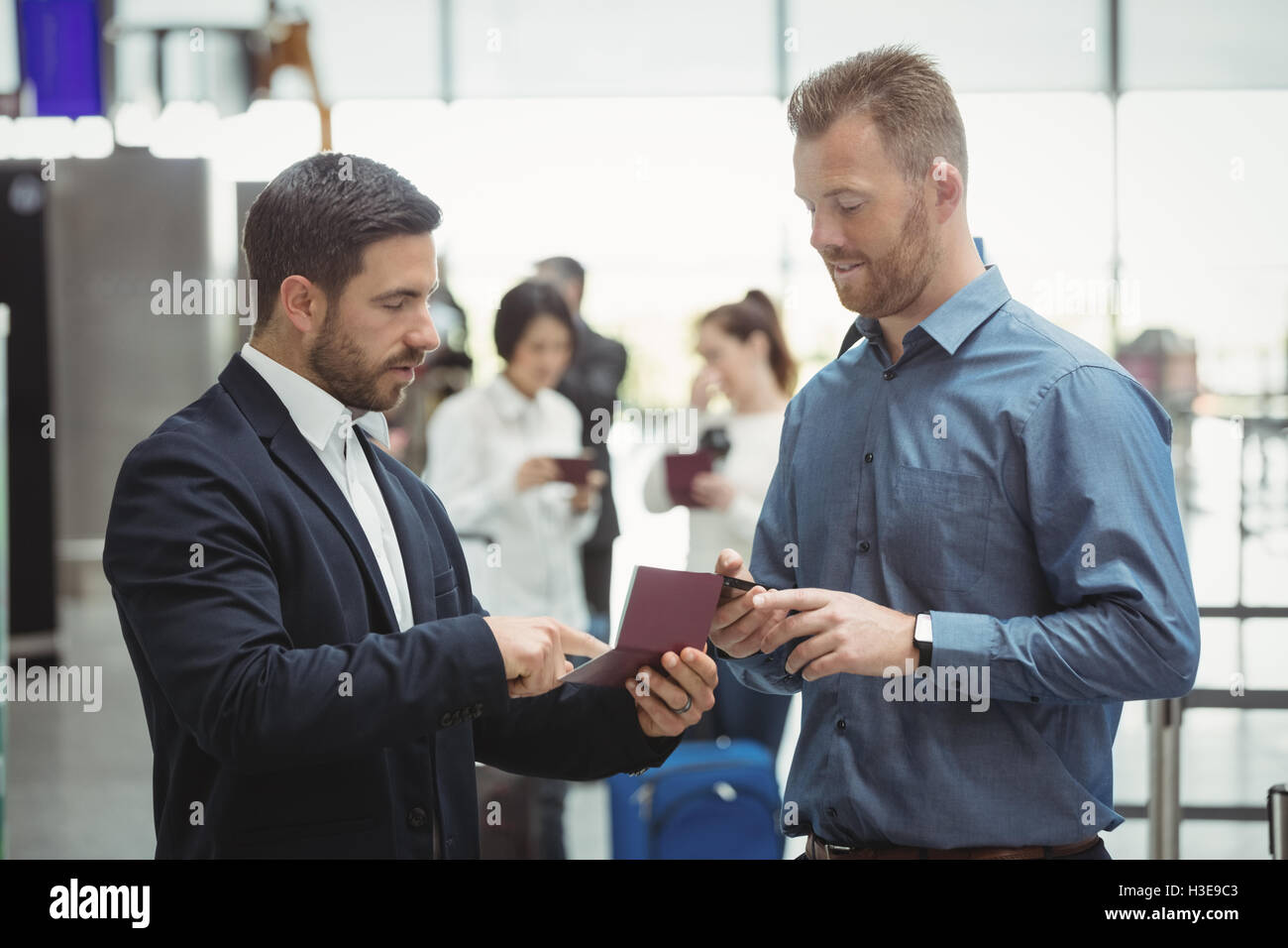 Business people checking their passport Stock Photo - Alamy