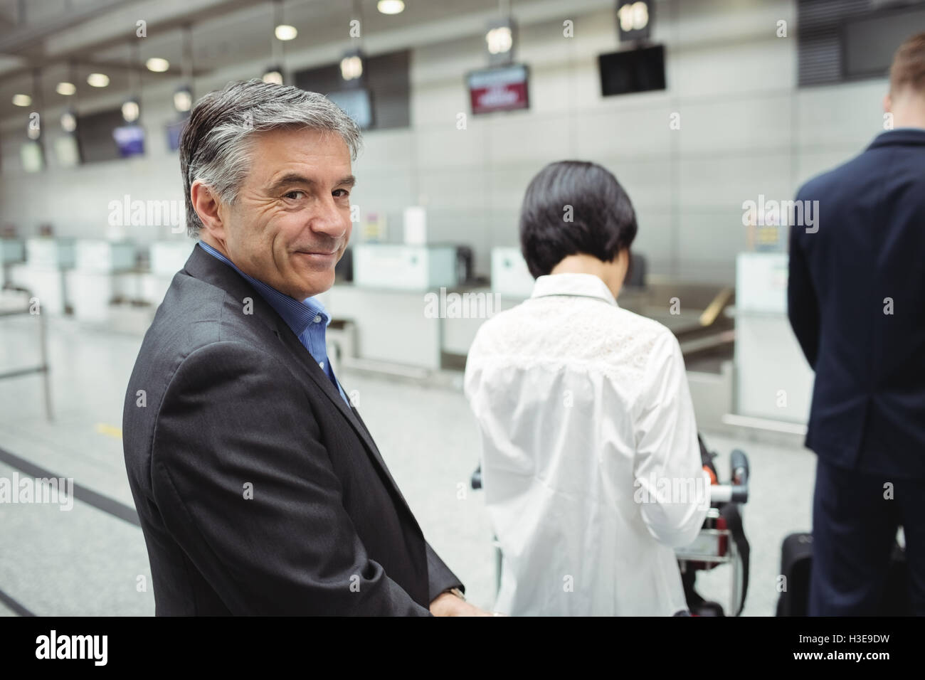 Business man waiting in queue at a check-in counter with luggage Stock ...