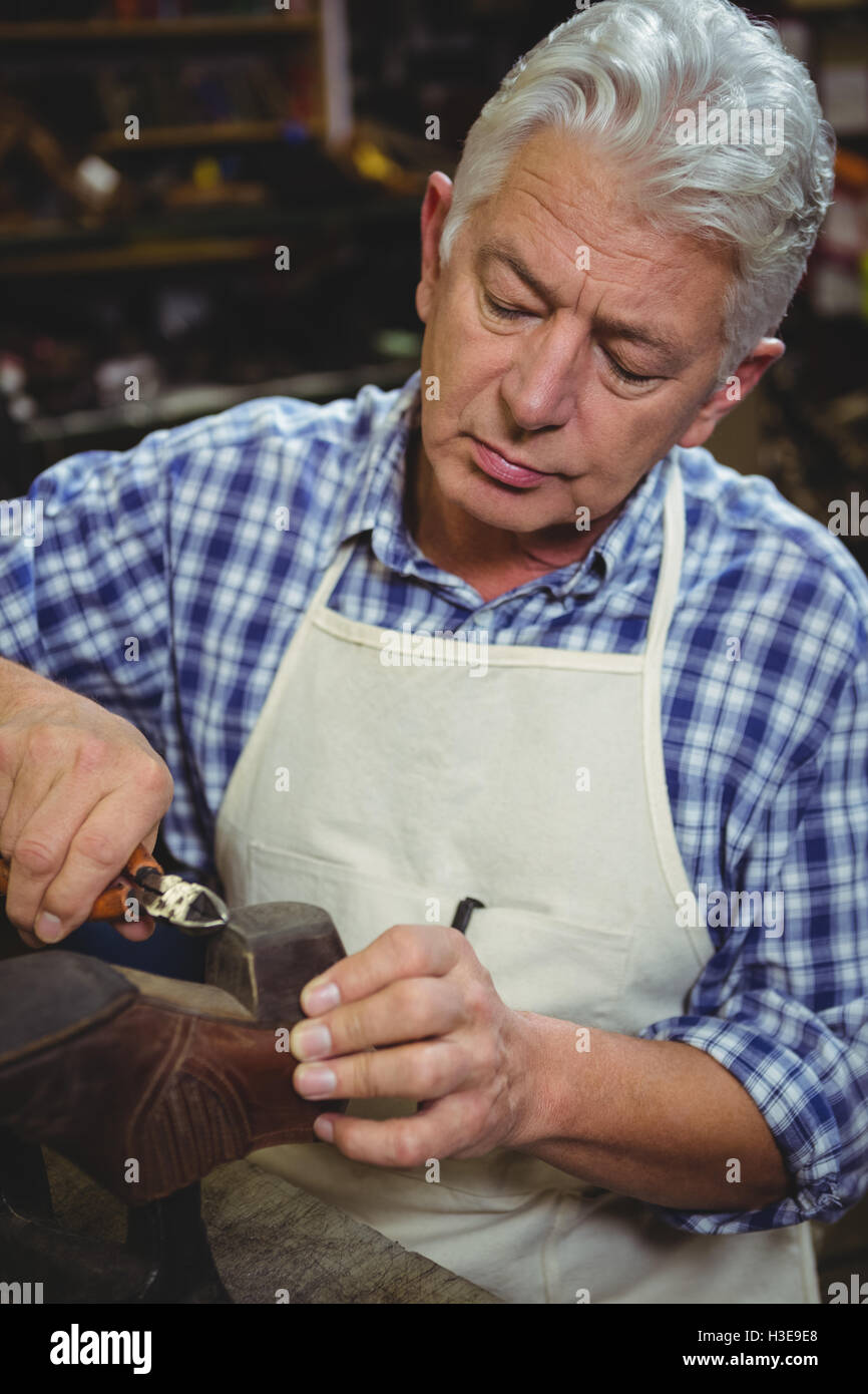 Shoemaker repairing a shoe Stock Photo - Alamy