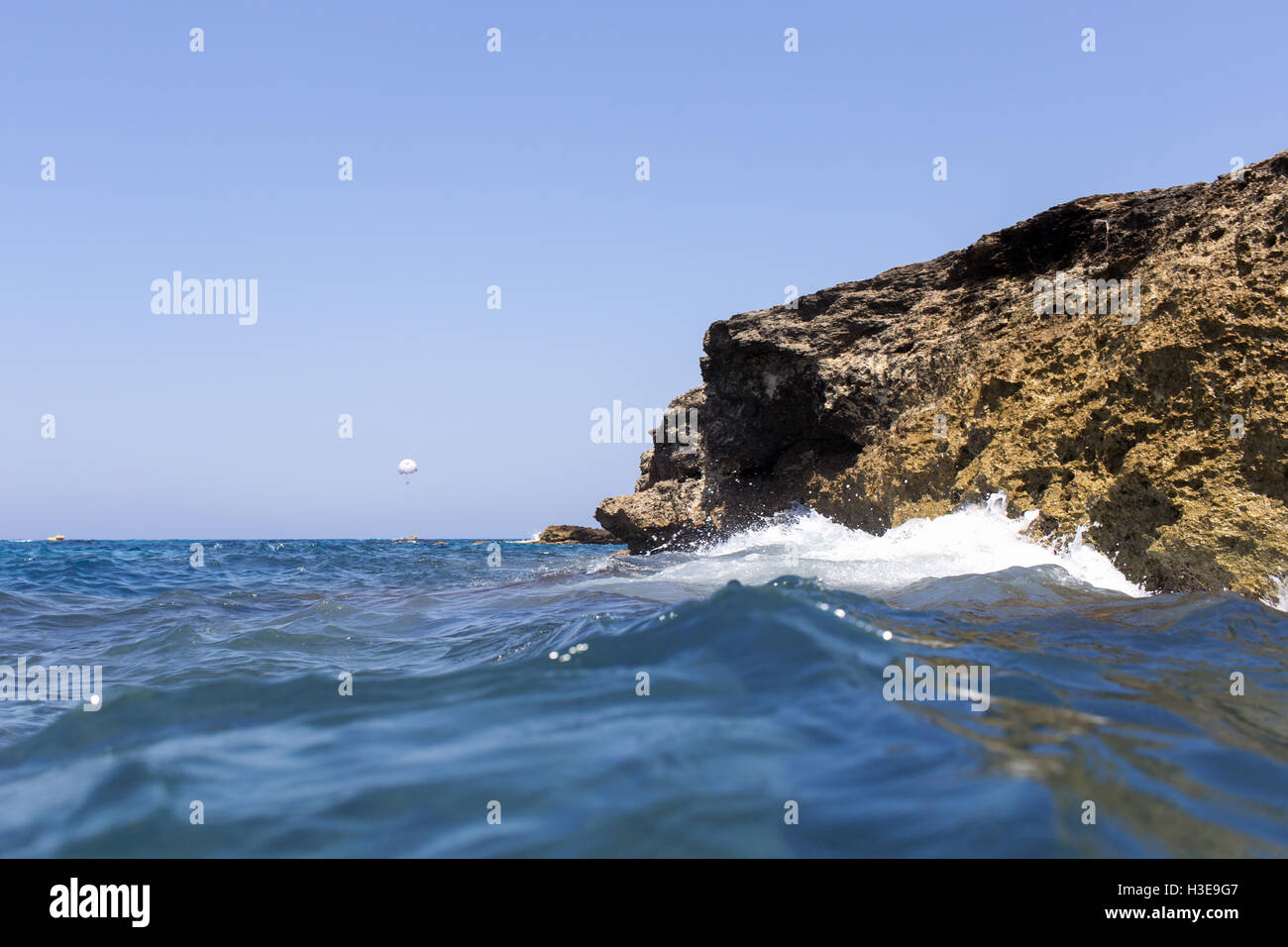 Sea wave splashing over the shore rocks with a high sea spray Stock ...