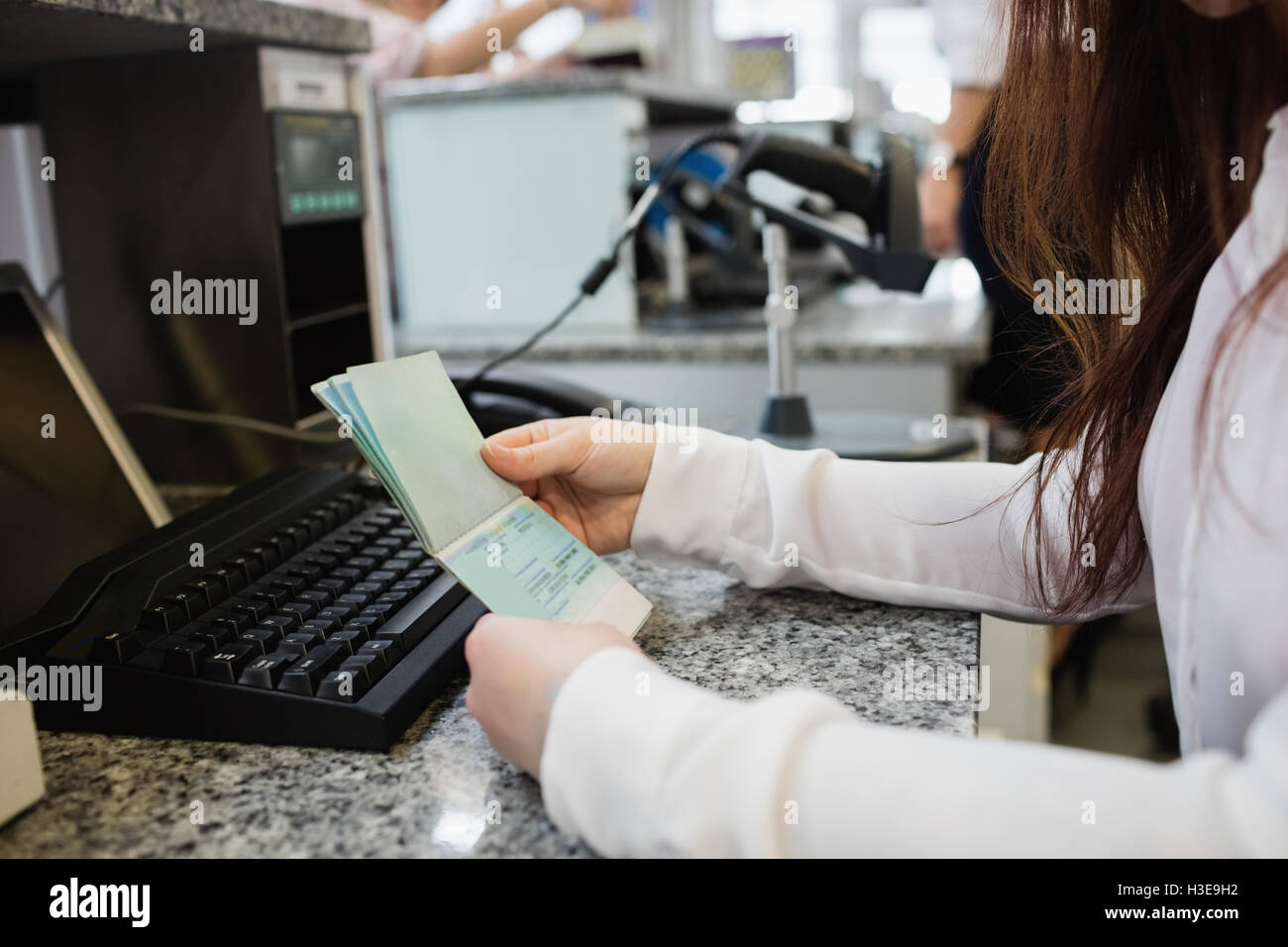 Woman checking in airport hi-res stock photography and images - Alamy