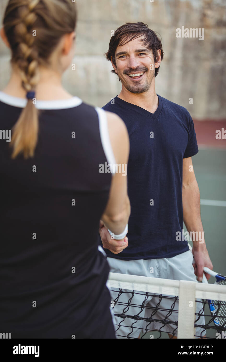 Tennis players shaking hands in the court Stock Photo - Alamy