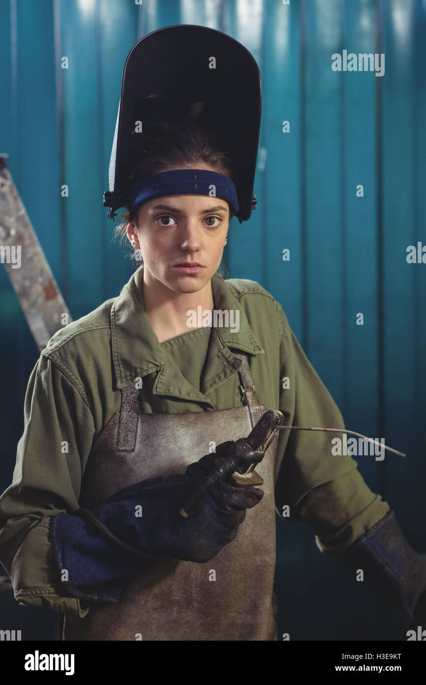 Portrait of female welder holding welding arch Stock Photo - Alamy