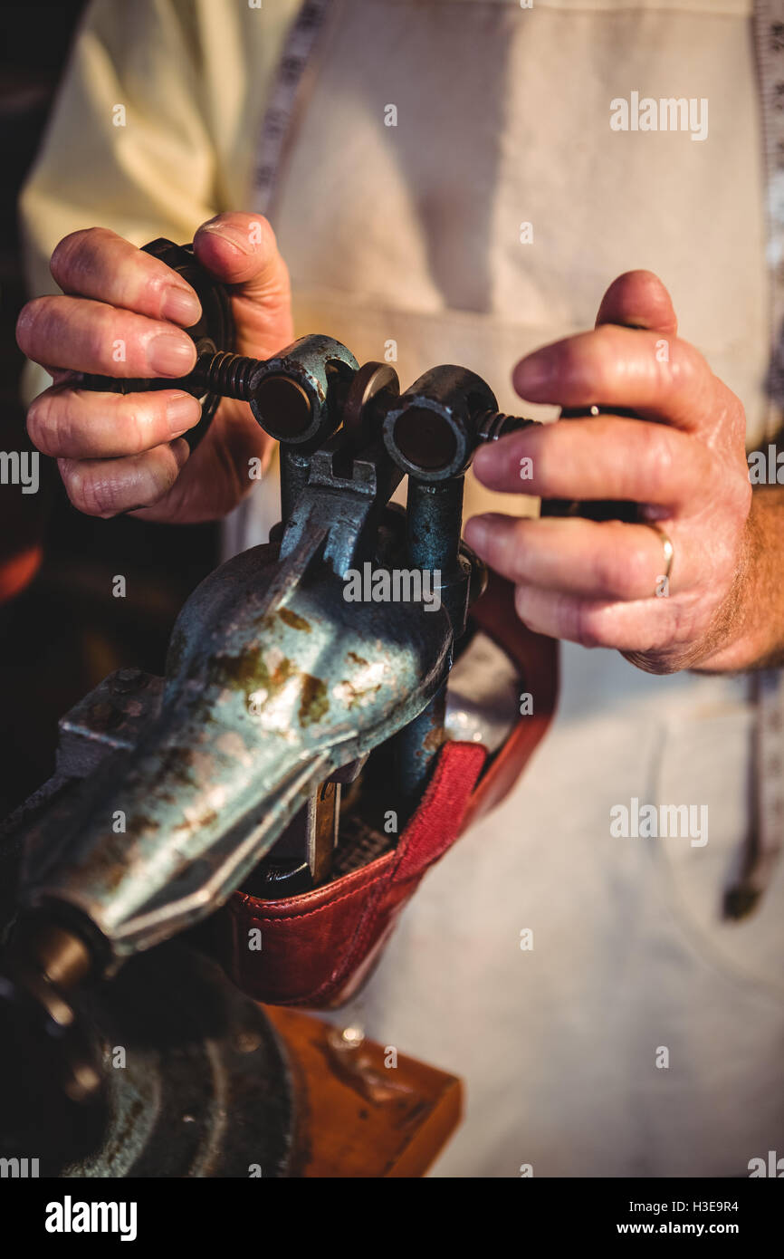 Shoemaker using shoe stretcher machine Stock Photo - Alamy