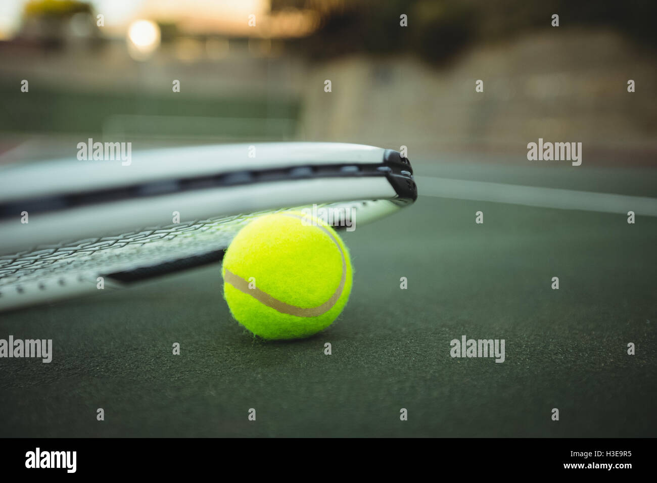 Tennis racket and ball lying in the court Stock Photo - Alamy