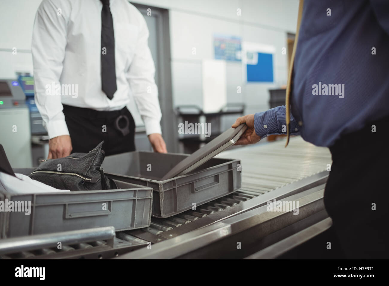 Airport security checkpoint tray hi-res stock photography and images ...