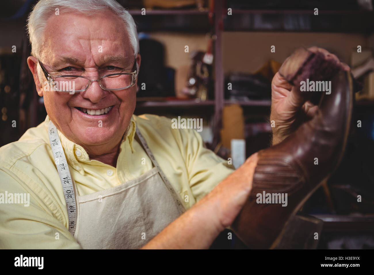 Portrait of shoemaker holding a shoe Stock Photo - Alamy