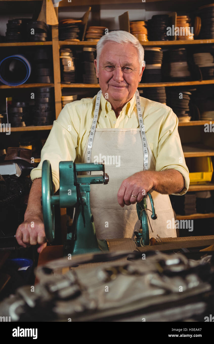 Portrait of shoemaker standing with sewing machine Stock Photo - Alamy