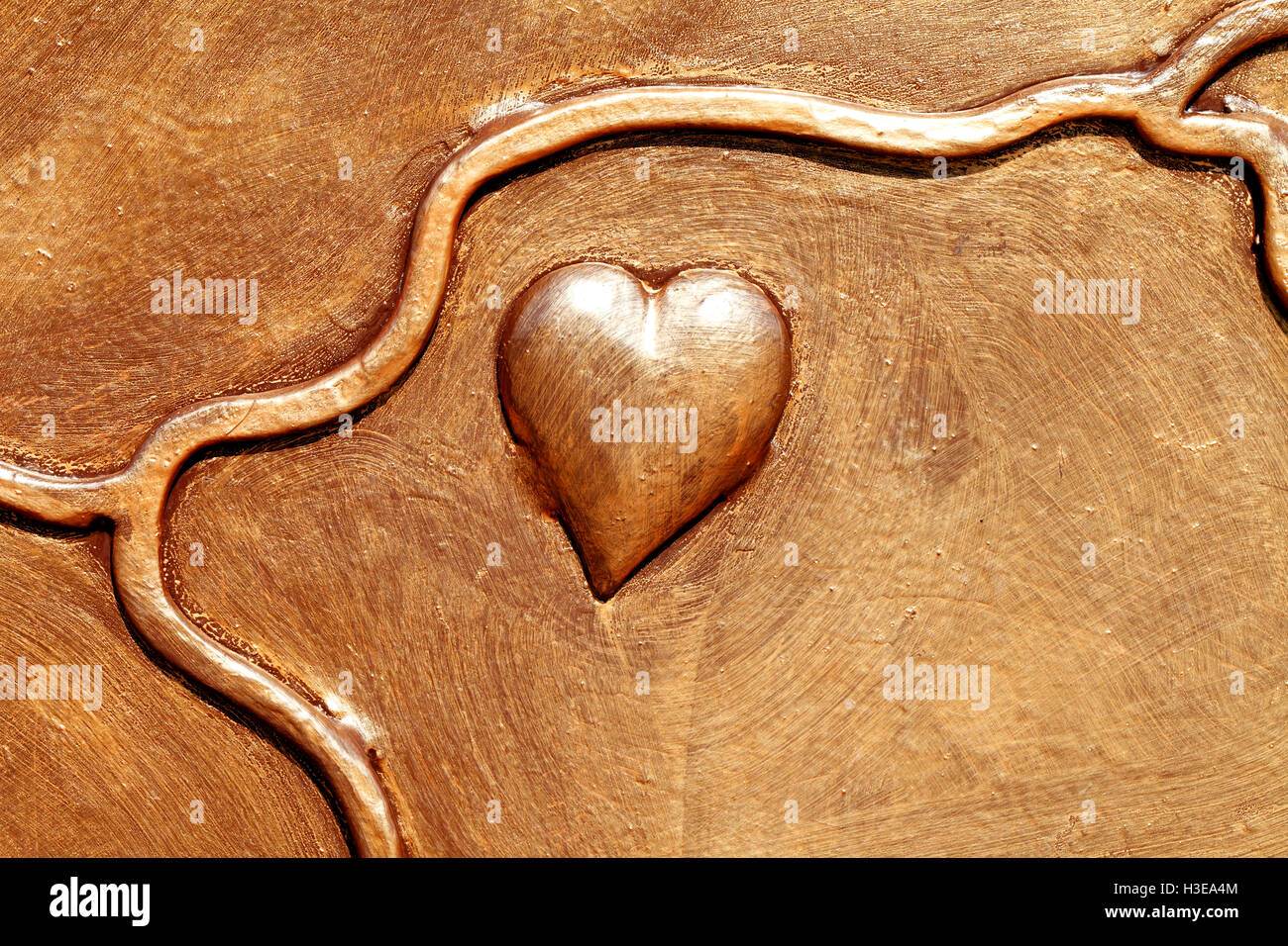 a beautiful heart of metal painted in gold paint Stock Photo - Alamy