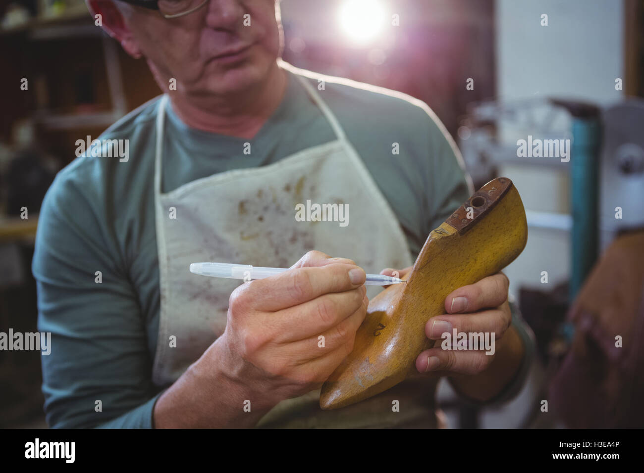 Shoemaker marking on shoe last with pen Stock Photo - Alamy