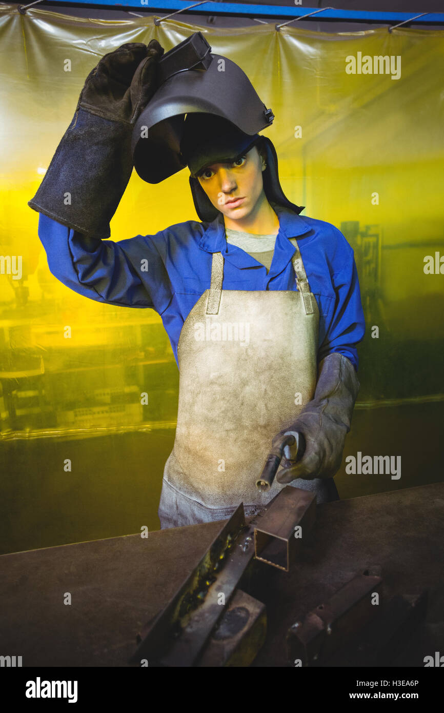Female welder holding welding torch Stock Photo - Alamy