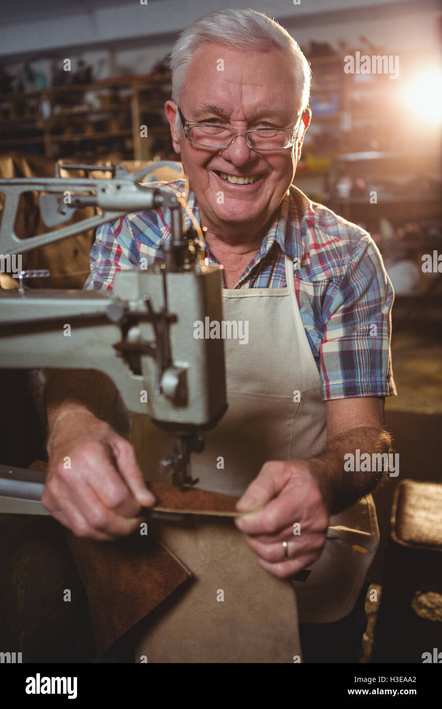 Portrait of shoemaker using sewing machine Stock Photo - Alamy