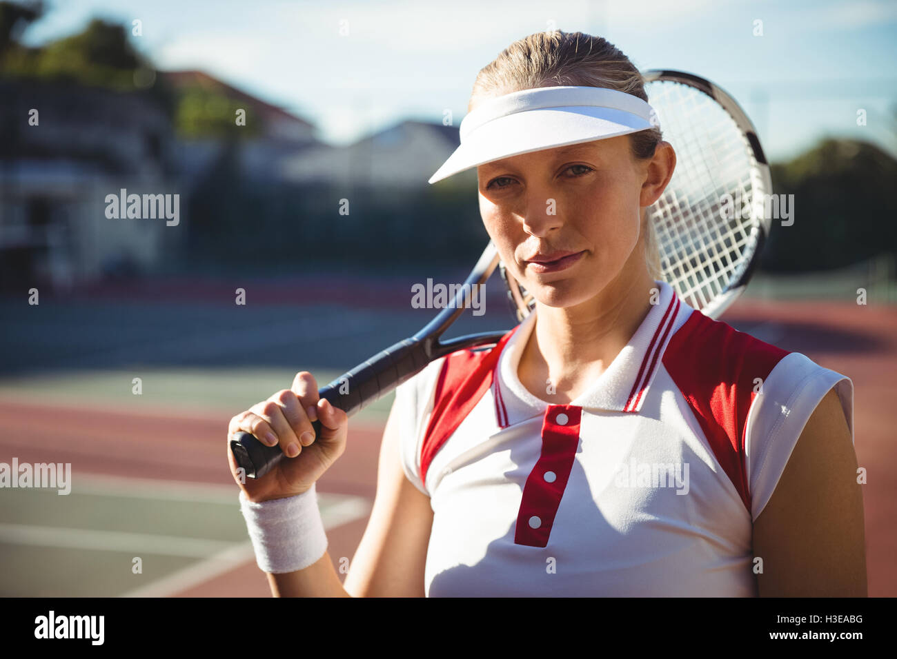 Portrait of female tennis player standing with a tennis racket Stock ...