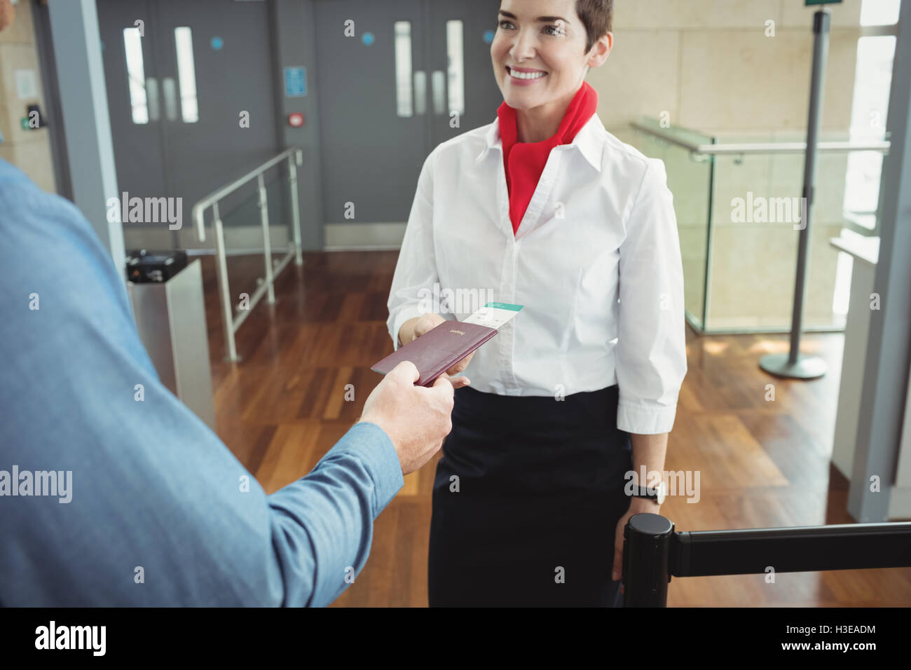 Businessman showing his boarding pass at the check-in counter Stock ...