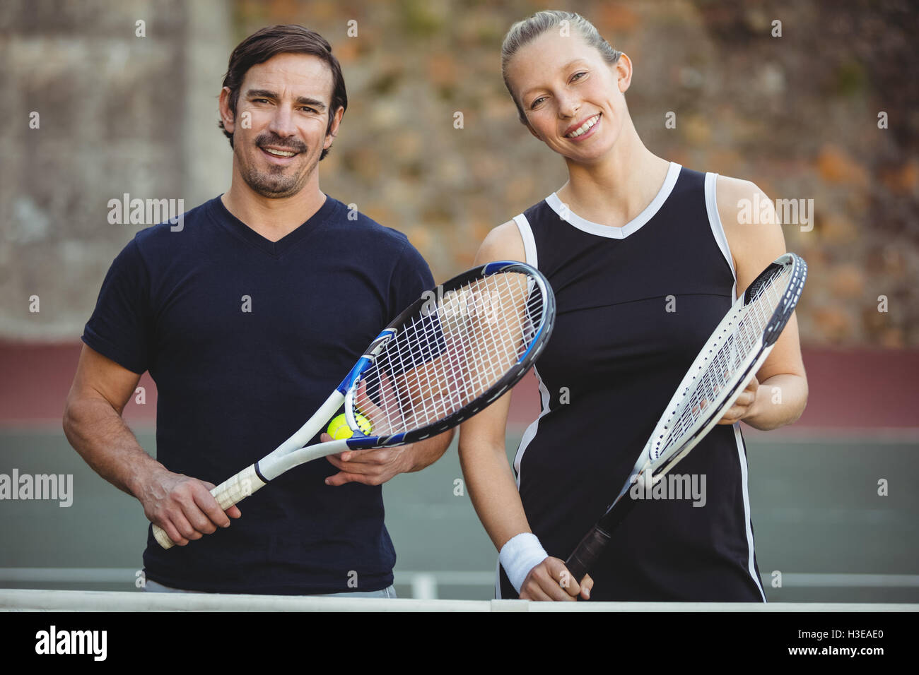 Portrait of two tennis players standing with racket Stock Photo - Alamy