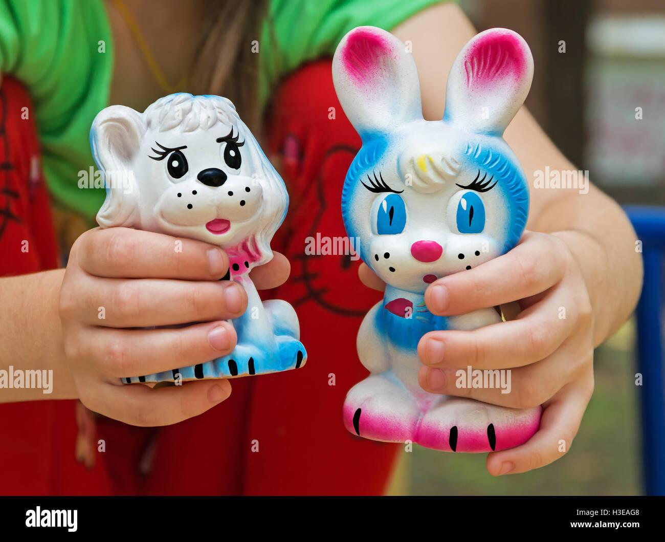 Old rubber toy in form of a colored rabbit and doggy for young children ...