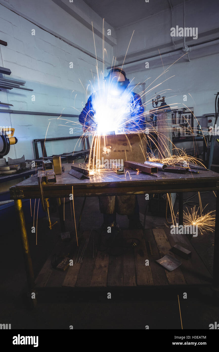 Male welder working on a piece of metal Stock Photo - Alamy