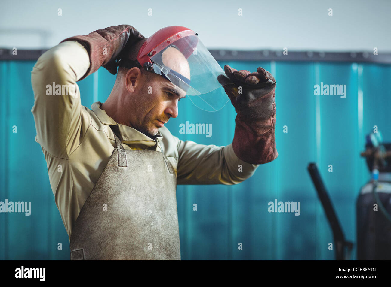 Male welder wearing protective helmet Stock Photo - Alamy