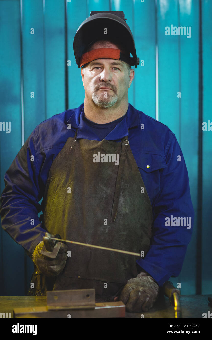 Male welder holding welding arch Stock Photo - Alamy