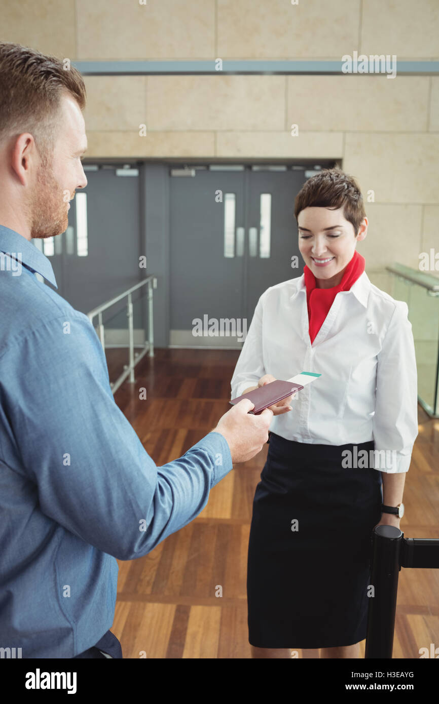 Businessman showing his boarding pass at the check-in counter Stock ...