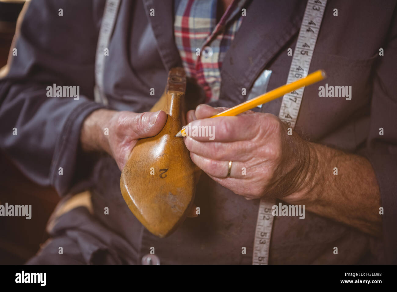 Shoemaker marking on shoe last with pen Stock Photo - Alamy